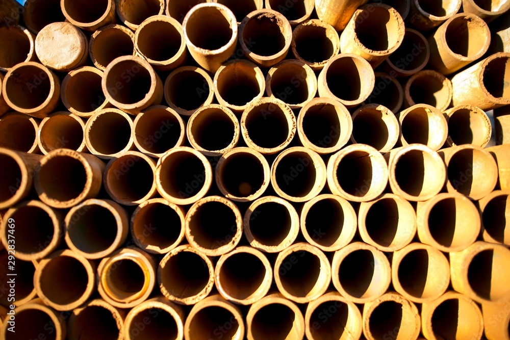 Round steel scaffold tubes stack on top of each other at laydown yard ...