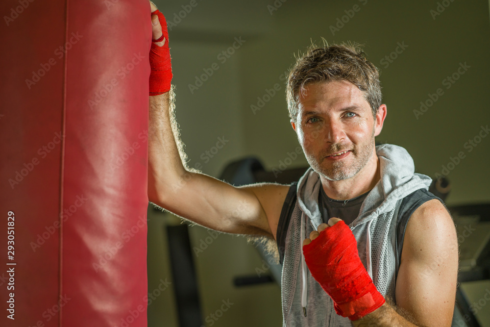 young happy and sweaty man boxing at gym working out sweaty in hoodie ...