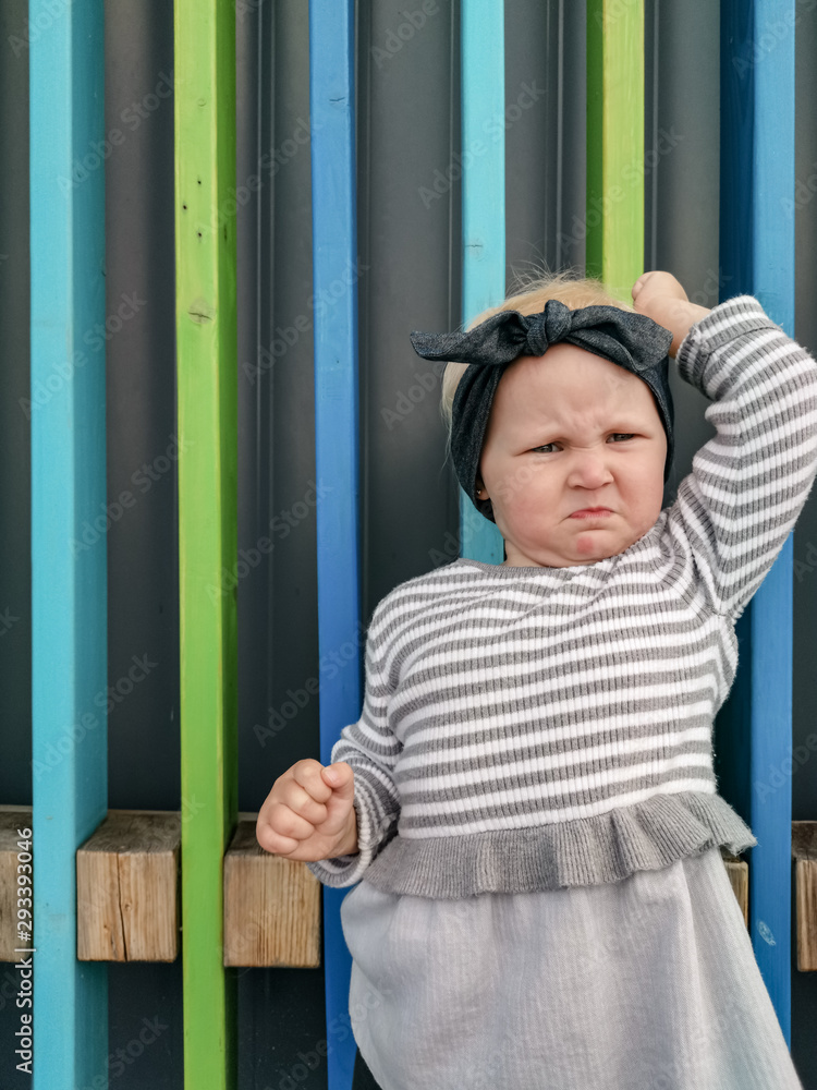 one very moody little girl waves her hand. very angry facial expression ...