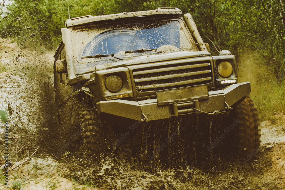 Mud and water splash in off-road racing. Offroad vehicle coming out of ...
