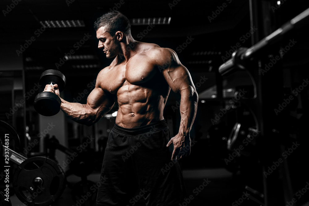 Muscular athletic bodybuilder fitness model training arms with ...