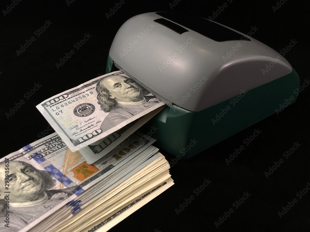 Automatic detector for checking banknotes. Dollars are checked through ...