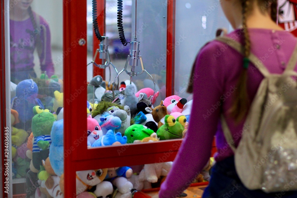 Caucasian girl playing toy crane vending machine, Claw Game or Cabinet ...