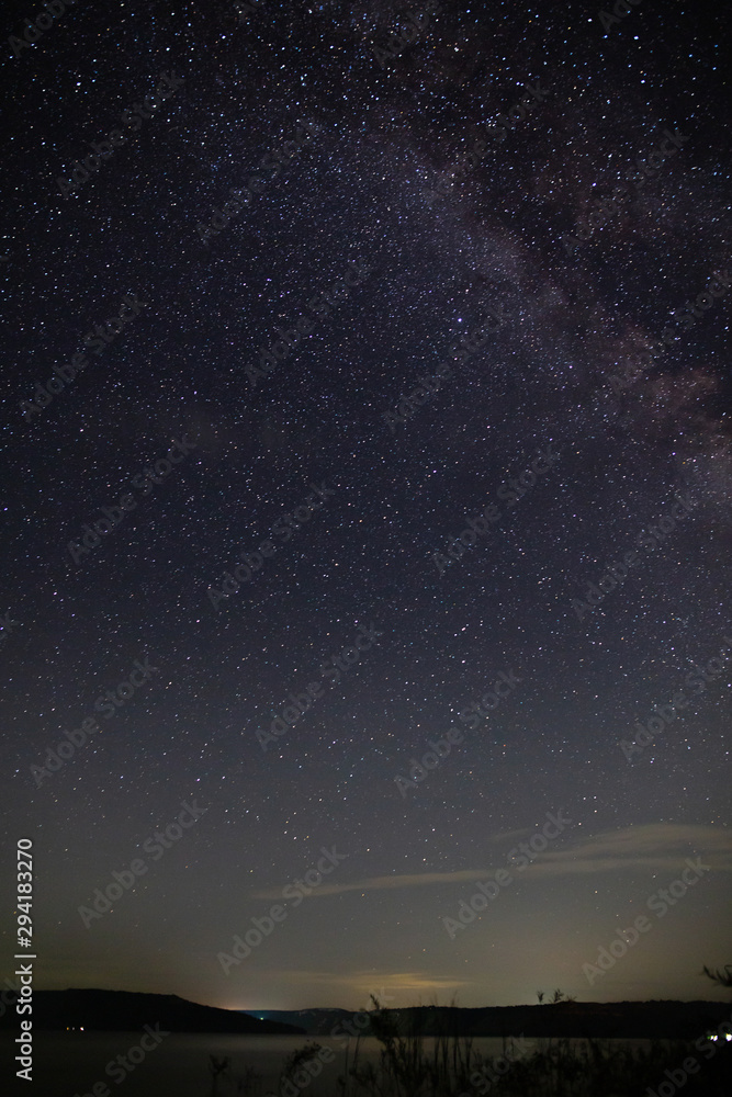 Amazing starry night sky above lake in mountains. Beautiful night sky ...