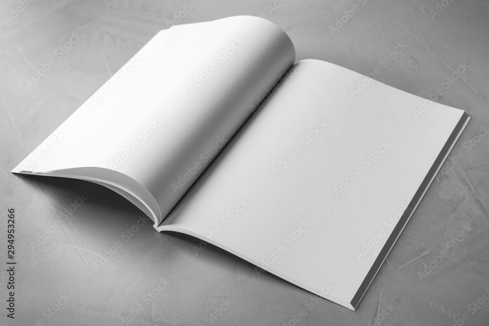 Blank open book on light grey stone background. Mock up for design ...