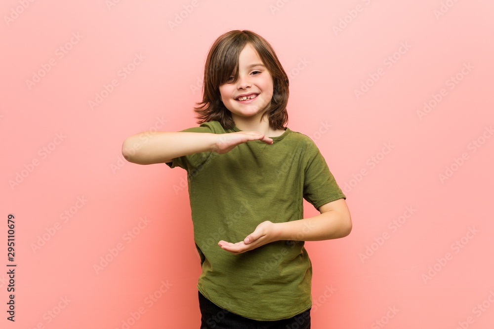 Little boy holding something with both hands, product presentation ...