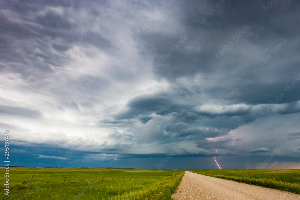 Single bolt of lightning hitting the ground from dramatic supercell ...