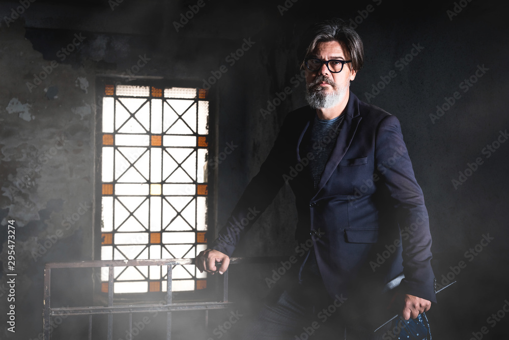 Portrait of mature handsome male model who posing in old abbandoned ...