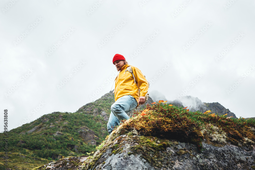 Brave tourist wearing yellow jacket with travel backpack hiking in ...