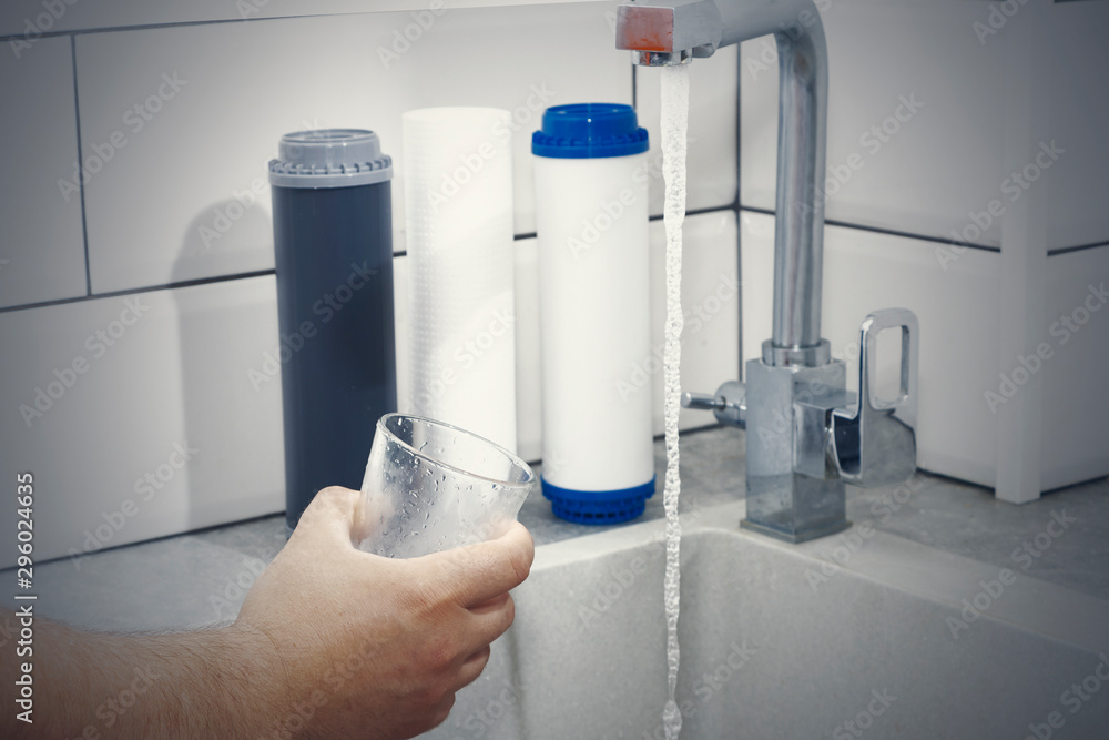 Replacing the water filter. Ecology. Clean water. Stock Photo | Adobe Stock