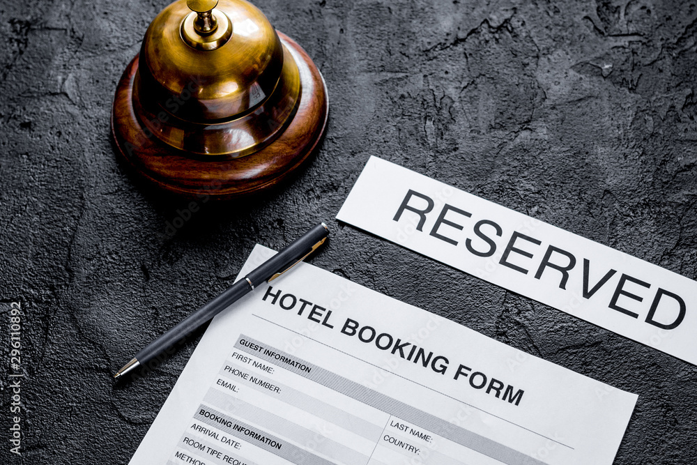 reservation form on hotel reception dark desk background Stock Photo ...