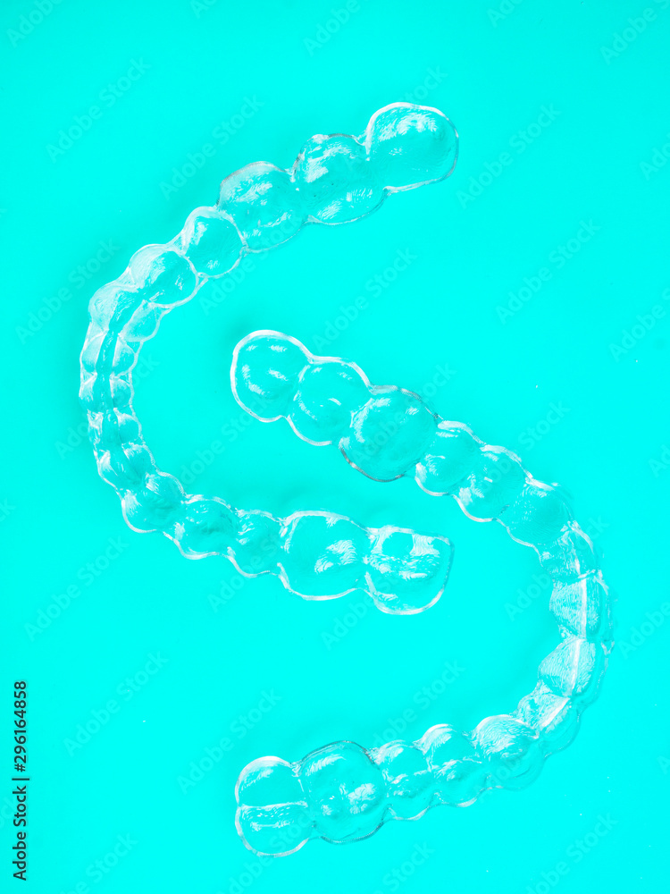 Invisible dental teeth brackets tooth aligners on blue background ...