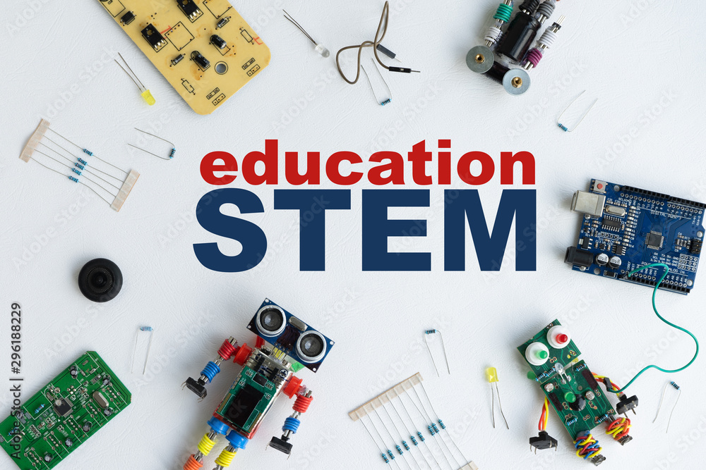 STEM school concept. A metal robot and an electronic board that can be ...