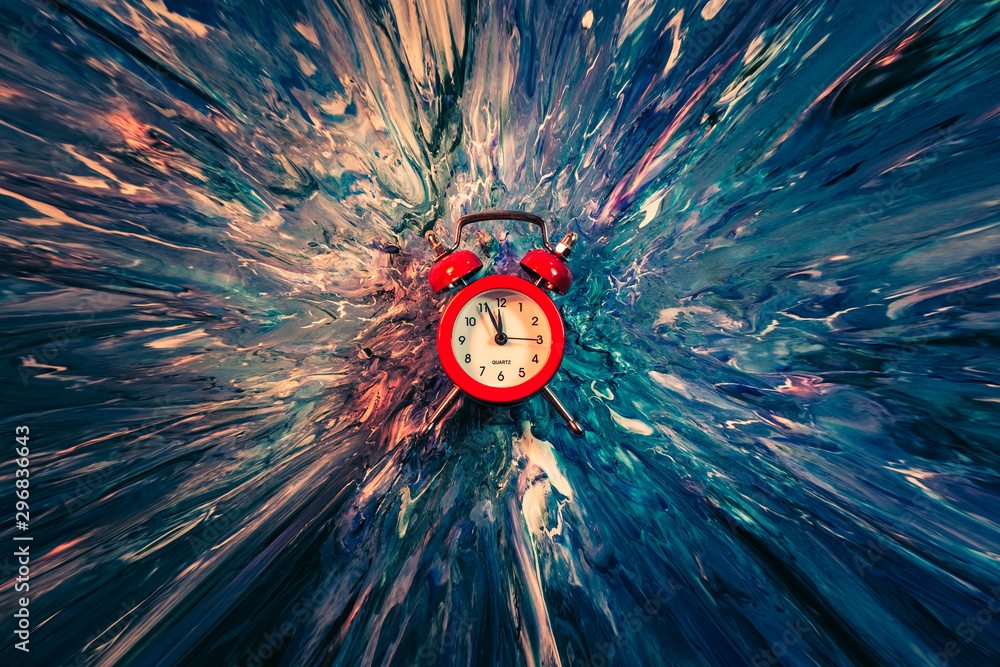 Time flies. Red vintage alarm clock falling down into blue and white ...