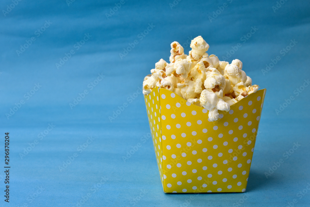 popcorn falling from paper packaging with blue background Stock Photo ...