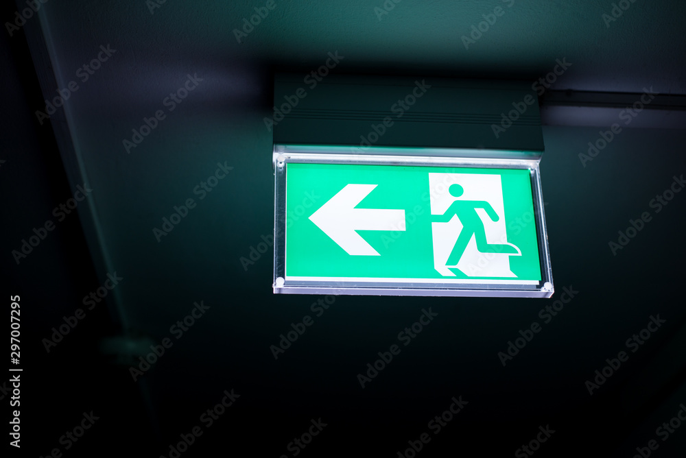 Close-up picture of led sign in corridor point way out of resident ...