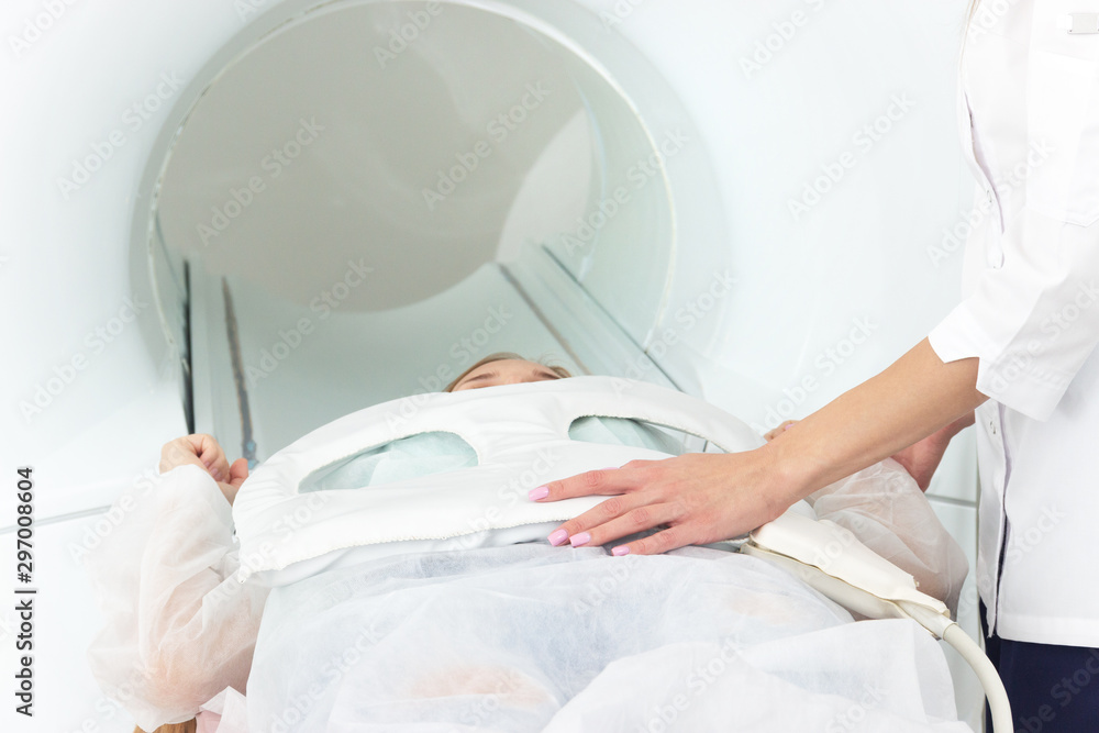 MRI scan of abdominal organs woman patient lying on a CT Scan bed ...