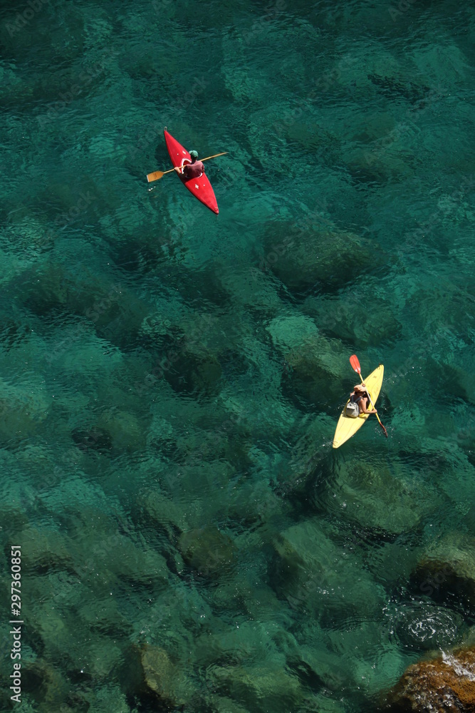 Colorful canoe on the transparent sea of the Cinque Terre. Top view ...