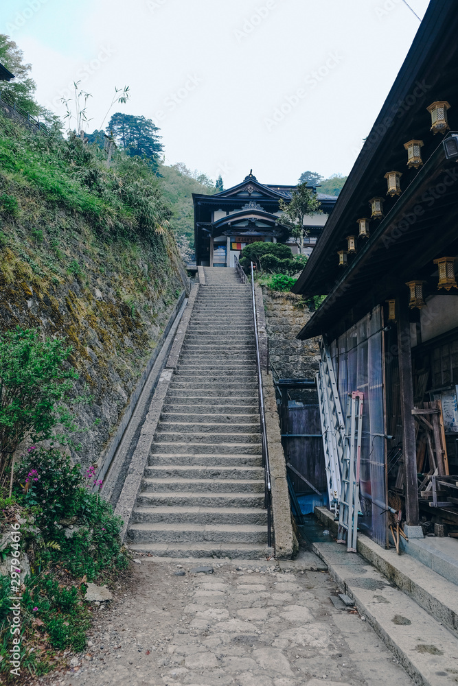 Long stone stairs to Japanese shrine (translation: japanese sign is ...