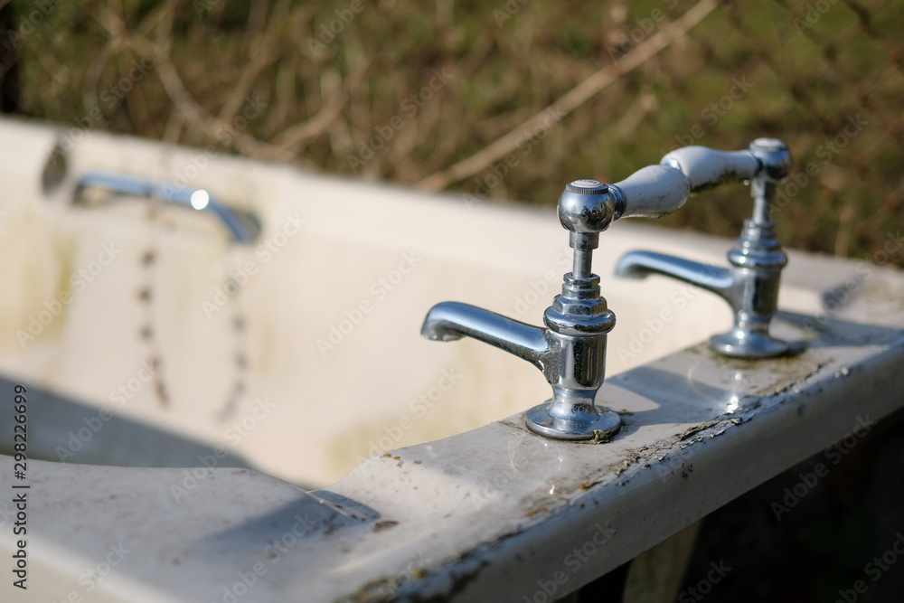 Foto de Stock Old, abandoned ceramic bath and chrome water taps as seen ...