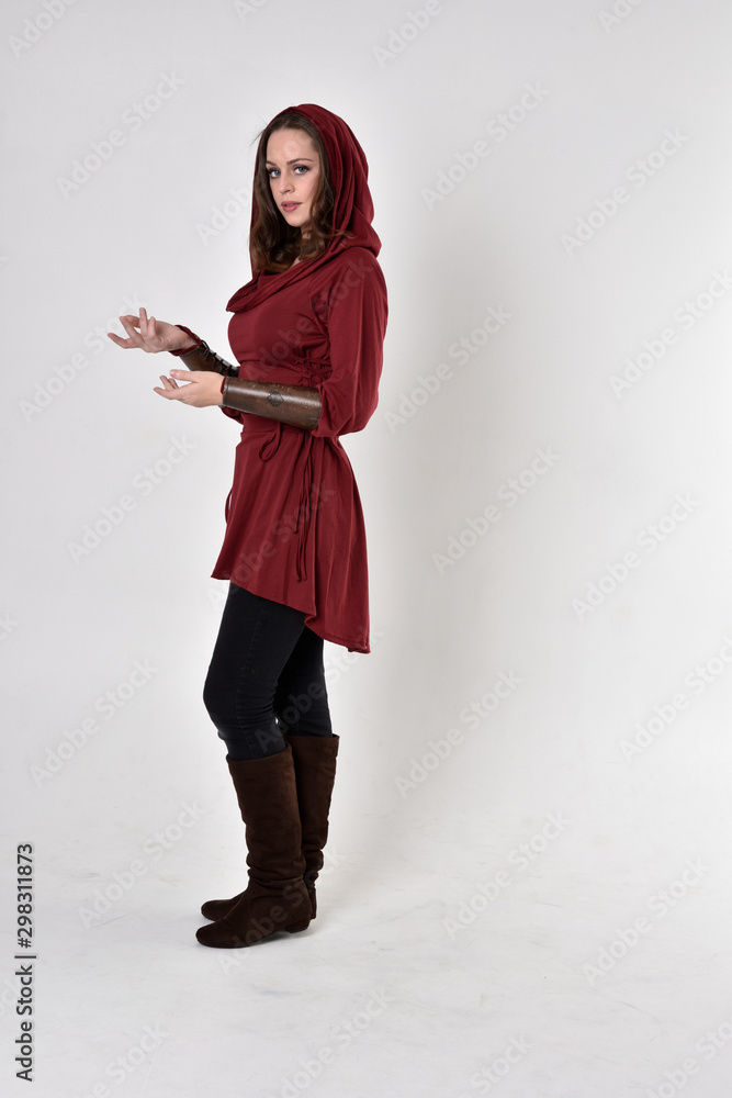 full length portrait of a brunette girl wearing a red fantasy tunic ...