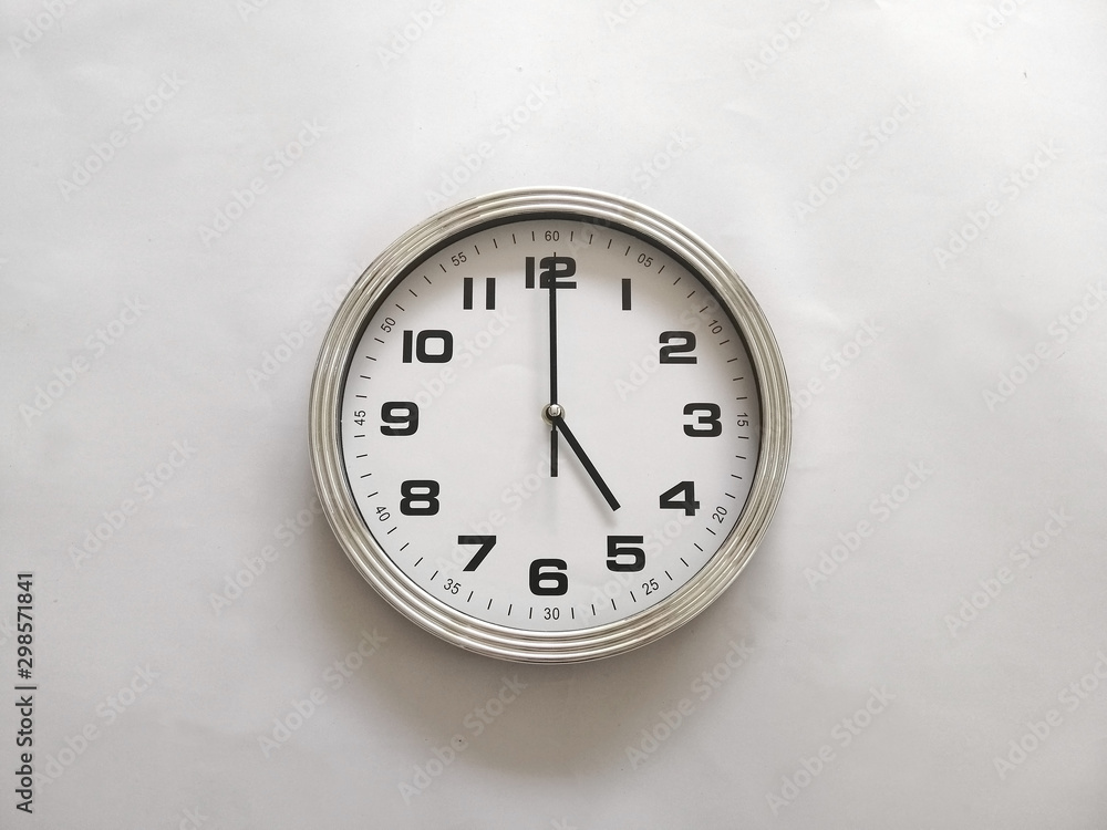 Wall clock isolated on a white wall, read at 5 o'clock. 5:00 pm, 5:00 ...
