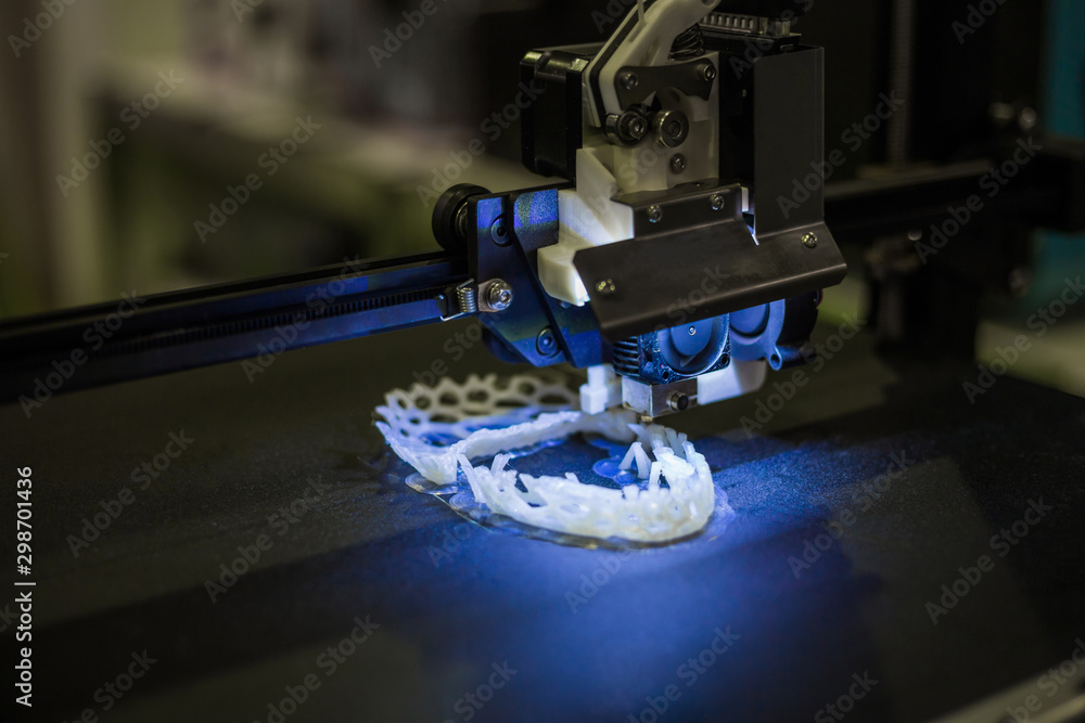 3D printer prints physical 3D model with plastic wire filament at ...