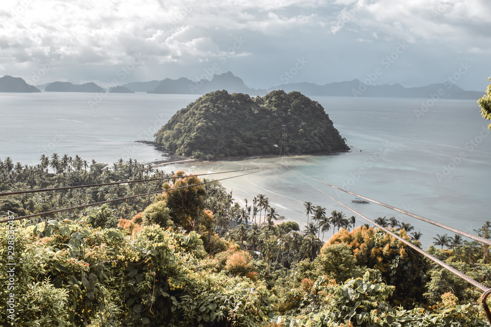 Cable line on a sea shore over green tropical jungle in El Nido Palawan ...