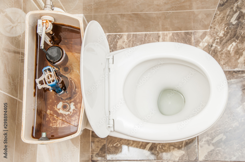 full toilet storage tank. Open mechanism. Float valve. Scale on the ...