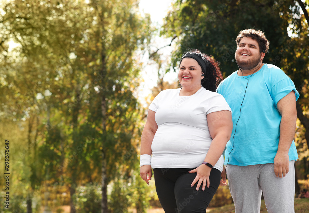 Overweight couple in sportswear together in park Stock Photo | Adobe Stock