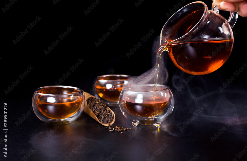 Chinese tea ceremony. Pouring of famous chinese puerh tea from a glass ...