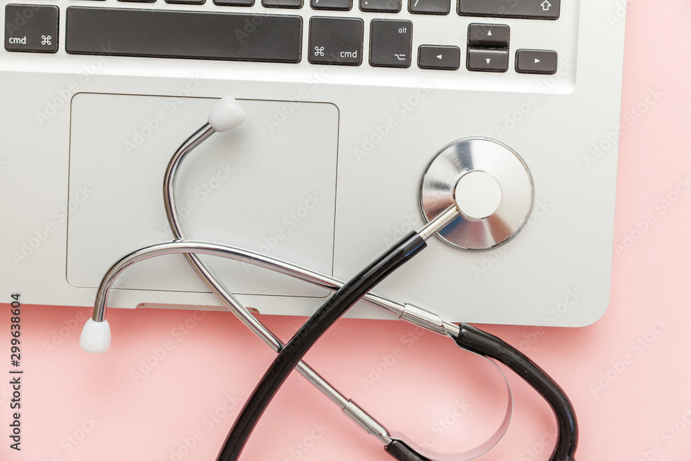 Stethoscope keyboard laptop computer isolated on pink background ...
