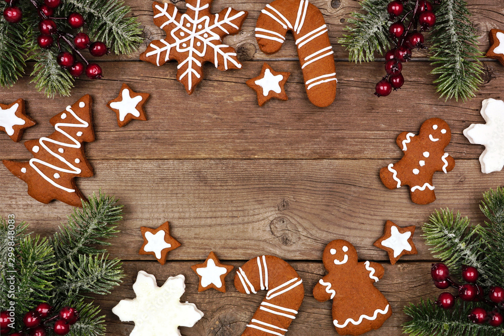 Christmas frame of gingerbread cookies and tree branches. Top view on a ...
