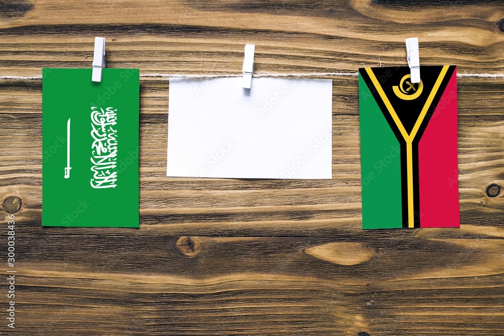 Hanging flags of Saudi Arabia and Vanuatu attached to rope with clothes ...