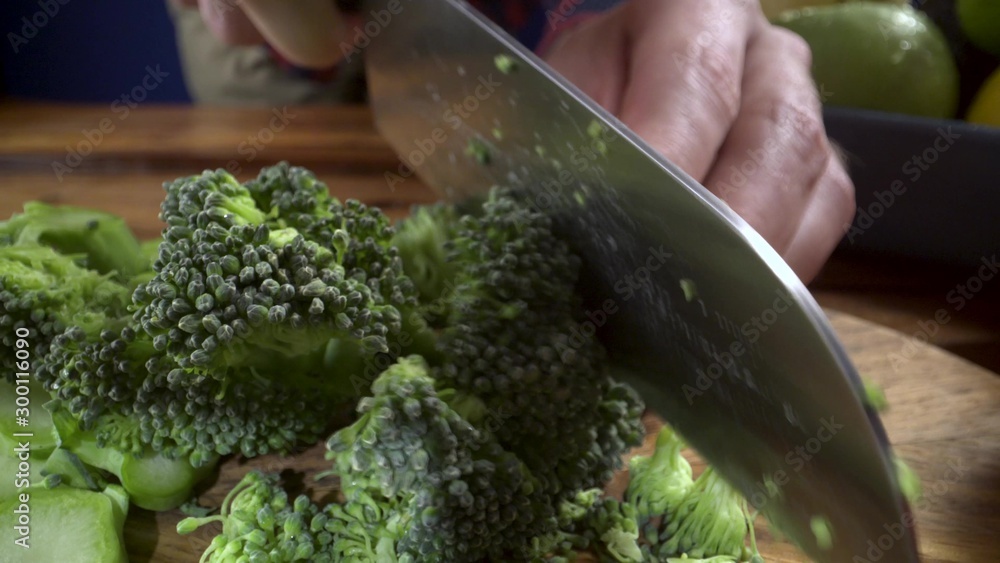 Healthy food, cook cuts a bunch of broccoli.. Healthy assortment of ...