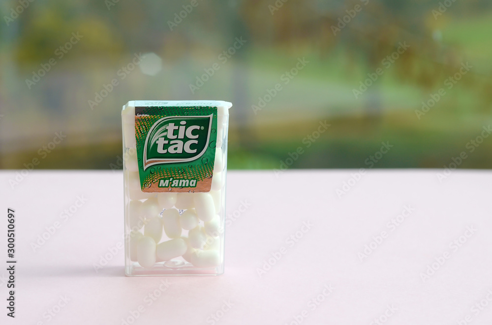 Many Tic Tac Candy packages on green wood background. Tic tac is ...