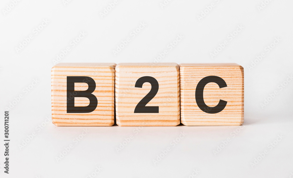B2C letters of wooden blocks in pillar form on white background, copy ...