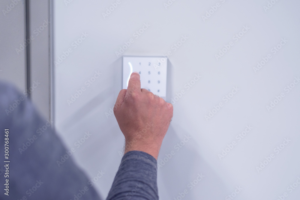 Young businessman entering access code at building entrance. The smart ...