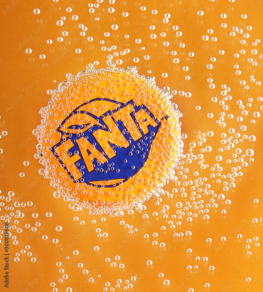 POLTAVA, UKRAINE - MARCH 22, 2018: Fanta cap in bubbles on a Orange ...