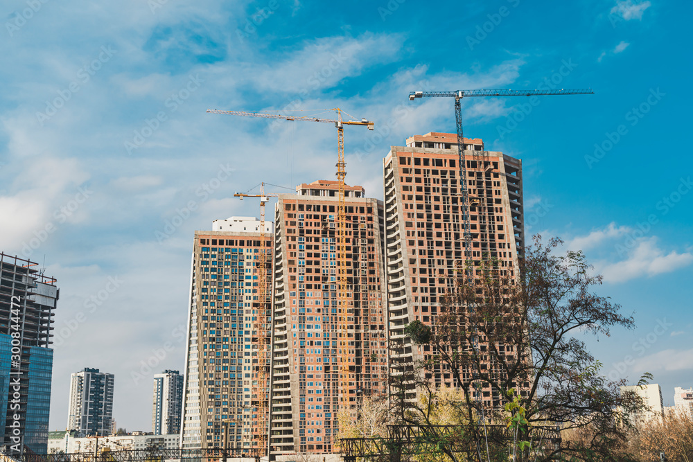 Construction of high-rise buildings in the city with tower crane with ...