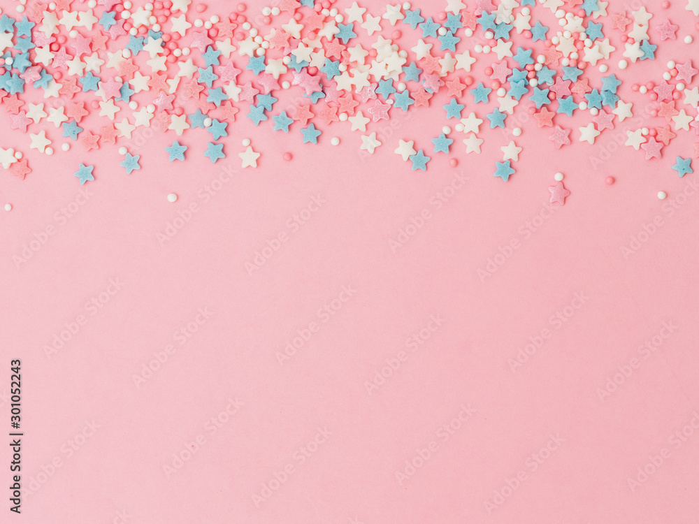 Festive border frame of colorful pastel sprinkles on pink background ...