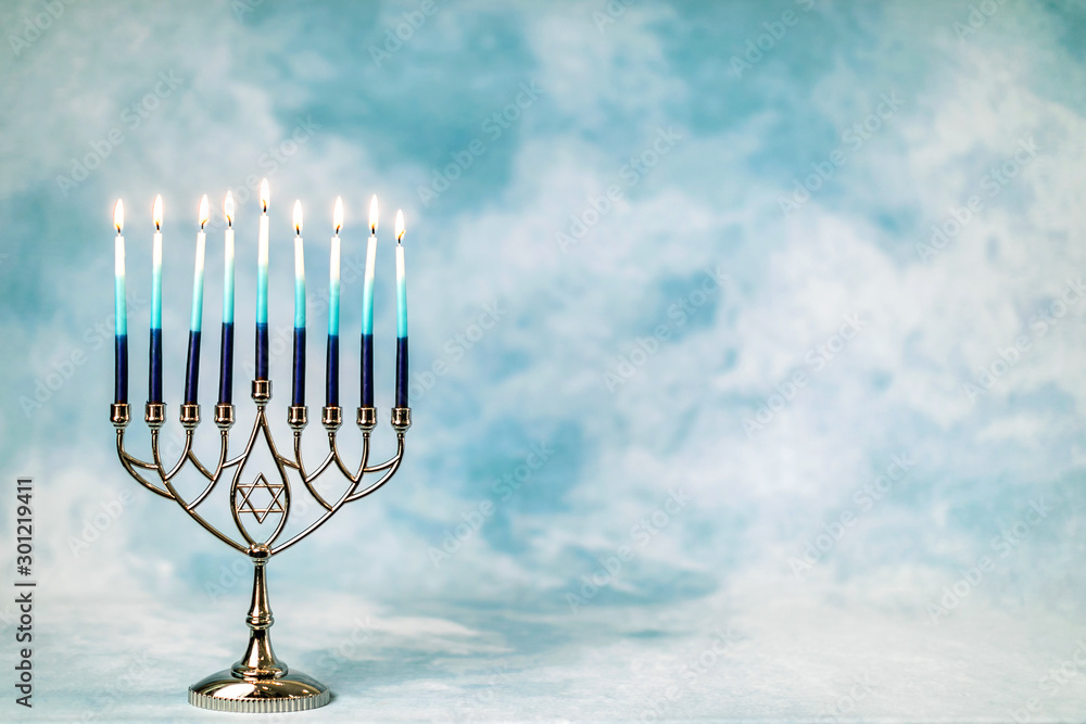 A silver menorah for the Jewish holiday Hanukkah with burning glowing ...