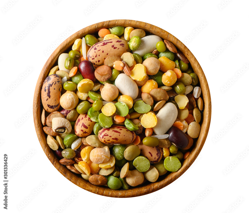 Various dried legumes in a small wooden bowl top view isolated on white ...