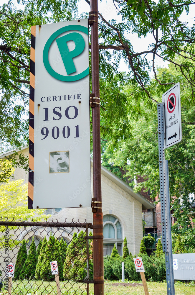Sign of ISO 9001 certificate on parking street in downtown. Stock Photo ...
