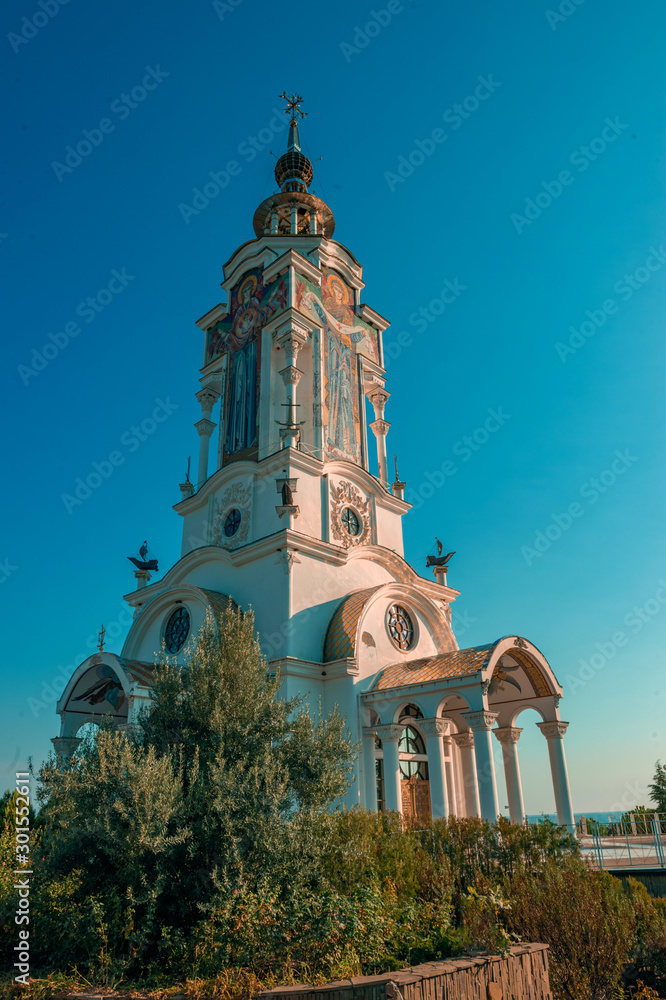 Temple lighthouse in honor of St. Nicholas on the seashore. Monument to ...