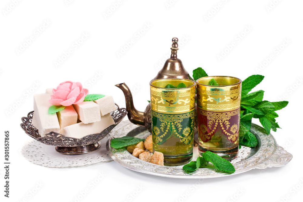 Moroccan tea with green mint and dessert with the mint leaves isolated ...