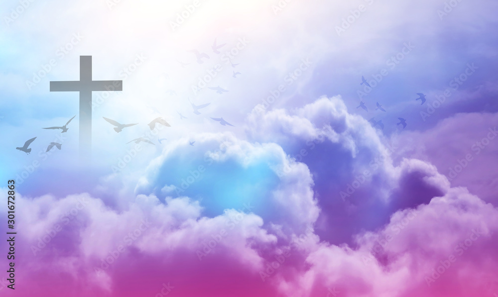 Christian cross appeared bright in the sky with soft fluffy clouds ...