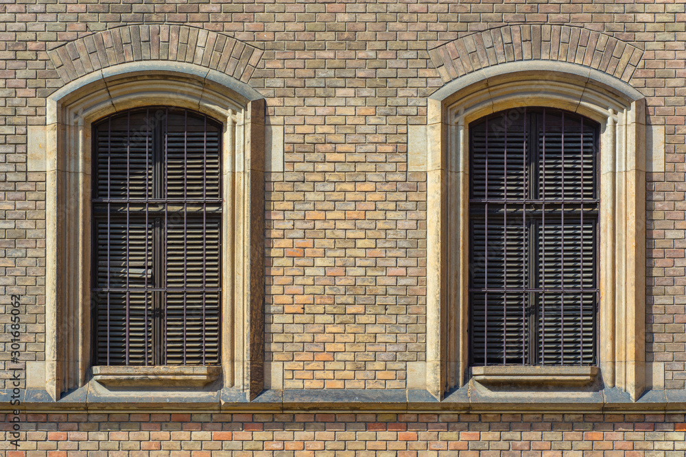 Windows with a powerful protective grill in an old urban residential ...