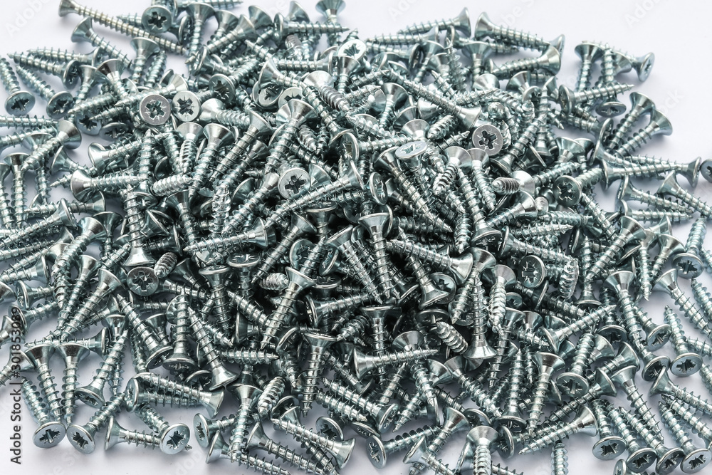 Big pile of metal galvanized screws. 20 mm screws top view. Fixing ...