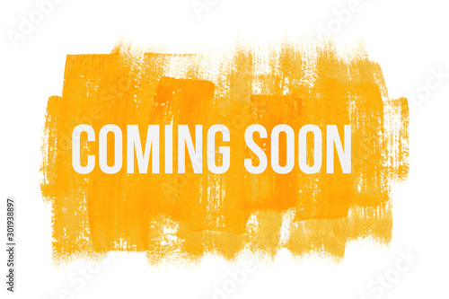 Coming soon on yellow paint background, isolated on white. Advertising ...